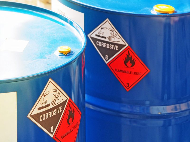 the close-up shot of blue color hazardous dangerous chemical barrels ...